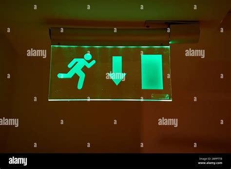 Emergency Exit Sign Glowing In The Dark Stock Photo Alamy