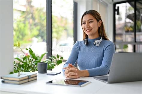 Asian Female Office Worker Concentrating On Her Female Manager