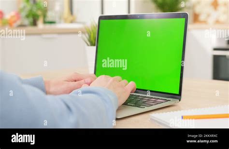 back view of man typing hand on keyboard laptop green screen chromakey