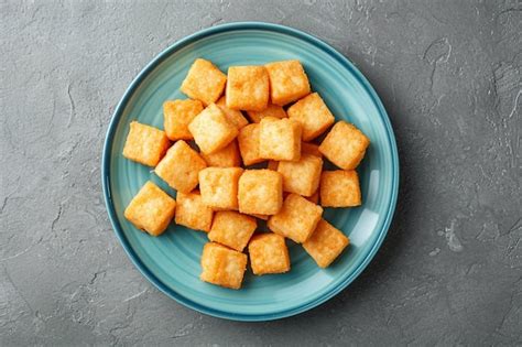 Premium AI Image Dices Of Fried Tofu On Plate Top View