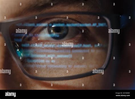 Extreme Close Up Of A Programmer Or Software Engineer Eye With Computer Code Reflecting On