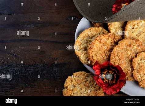 Australian Army Slouch Hat And Traditional Anzac Biscuits On Dark