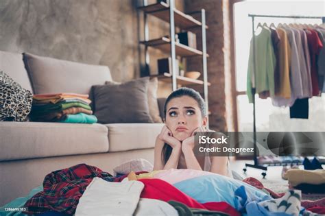 꽤 스트레스 울고 여자의 사진 은 많은 옷 힙 스택 바닥 옷장 물건 선택 날짜 보기 의상 실내에서 착용 아무것도 누워 집 검역을