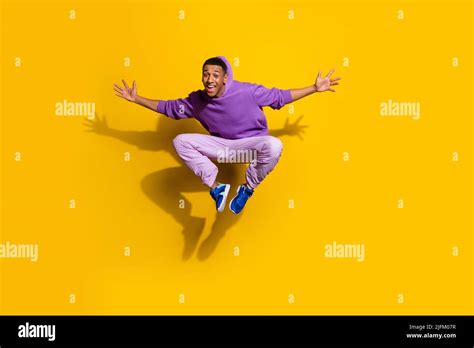 Full Length Body Size View Of Handsome Trendy Cheerful Guy Jumping