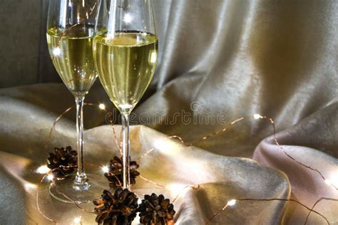 Two Champagne Glasses Against Blurred Lights Background Bokeh Effect