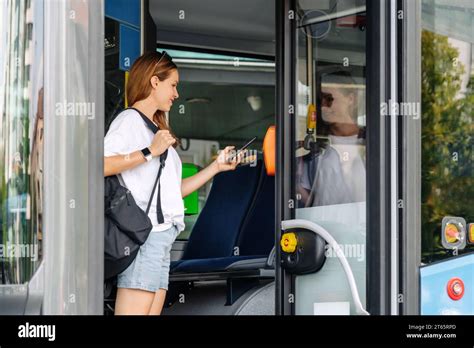 Urban Woman Passenger Of Public Transportation Pays Bus With Her Mobile