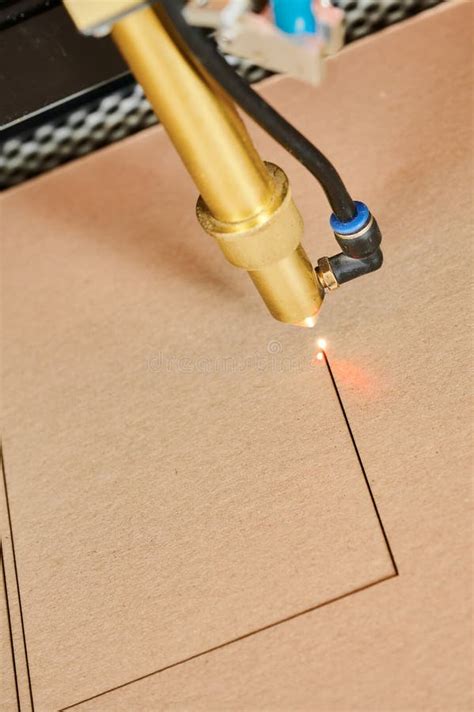 Precision Laser Cutting Shapes Cardboard Sheets In A Modern
