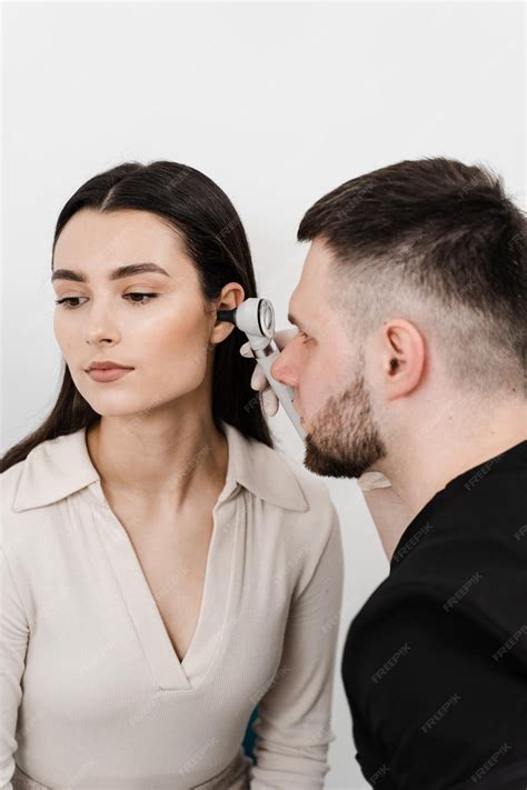 Premium Photo Closeup Examination Of Womans Ear With Otoscope