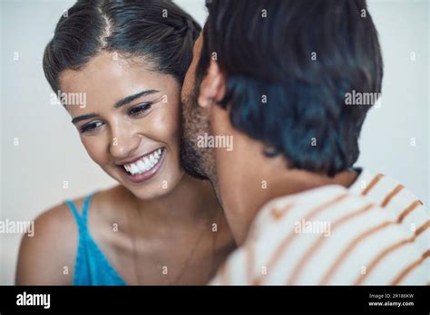 Whispering Sweet Nothings In Her Ear An Affectionate Young Couple