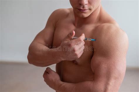 A Muscular Man With A Naked Torso Holds A Dope Syringe Unrecognizable
