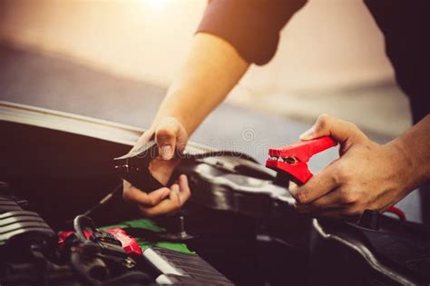 Hand Car Mechanic Holding Car Booster Cables For Jump Start Car For