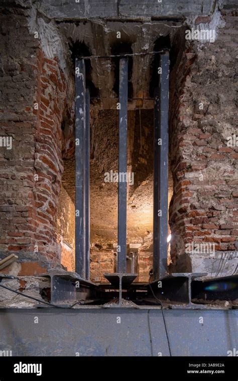 Exposed Steel Beams Integrate With Rough Brickwork Highlighting Architectural Elements Of A