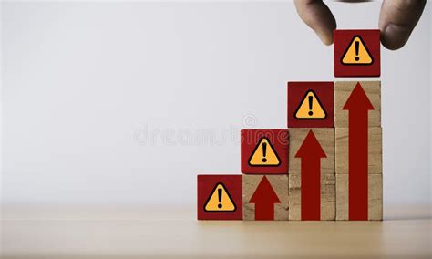 Hand Putting Exclamation Waring And Caution Sign Symbol On Red Up Arrow
