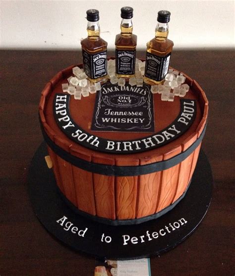 A Birthday Cake Made To Look Like A Barrel With Three Bottles Of