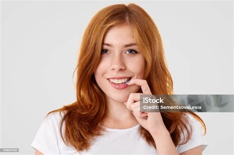 주 근 깨 피부 젊은 여성을 긍정적인 유지 앞 입 미소 근처 광범위 하 게 손가락 붉은 머리 화이트 치아 스튜디오 배경 위에