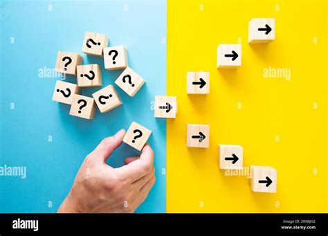 A Hand Choosing A Block With A Question Mark For Making The Right