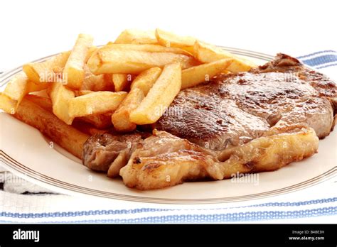 Freshly Cooked Sirloin Beef Steak And Chips Isolated Against A White