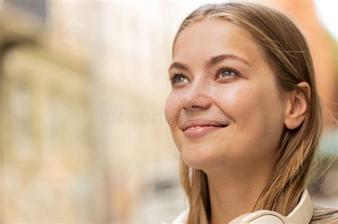 Thoughtful Young Woman Tourist With Wireless Headphones Around Neck