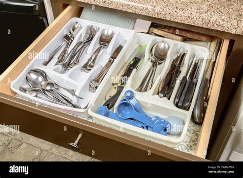 Horizontal Shot Of A Messy And Cluttered Silverware Drawer In The Home