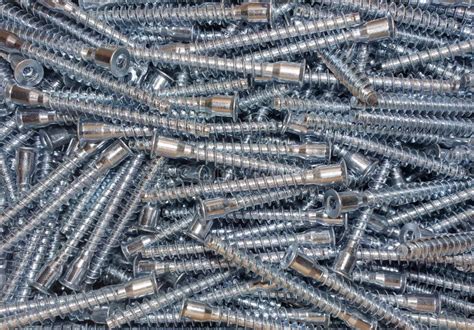 Multiple Screws And Nuts On The Surface Of A Metal Sheet Stock Image Image Of Silver Rust
