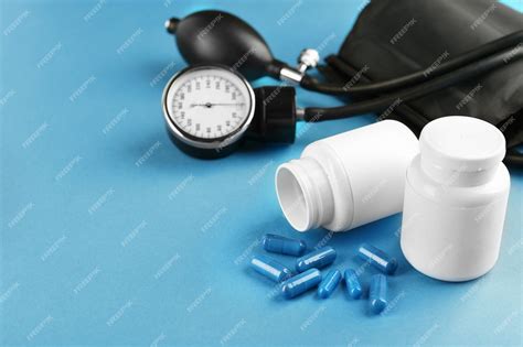 Premium Photo Medical Manometer And Pills On Blue Background