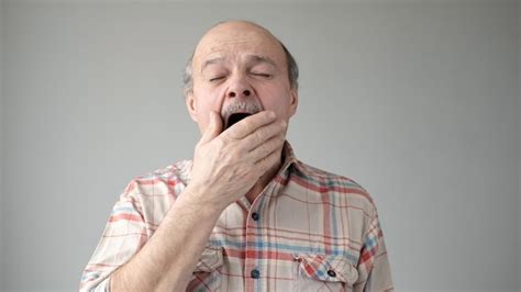 Sleepy Senior Hispanic Man Yawning Being Tired Premium Photo