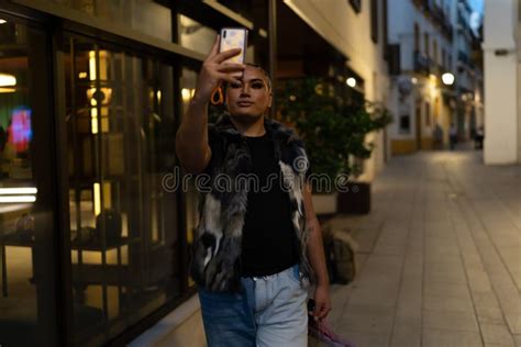 An Adult Non Binary Gender While Shopping With Bags Takes A Selfie Concept Of Technology