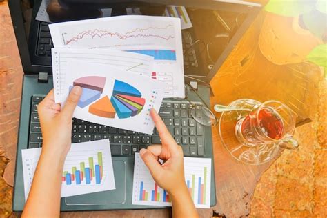 Premium Photo Cropped Image Of Woman With Graphs At Table