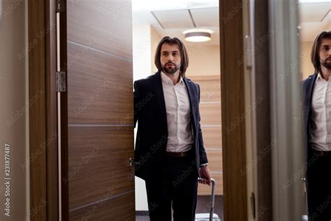 In The Hotel Room Pleasant Good Looking Man Opening The Door While