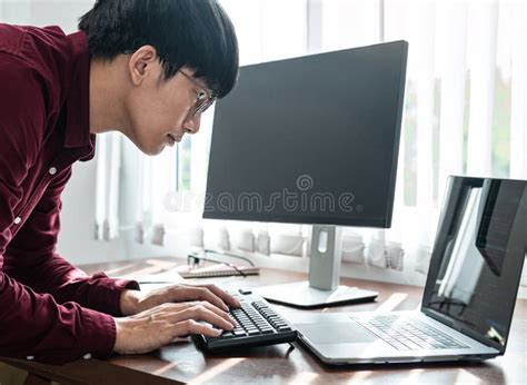 asian man programmer looking on screen laptop to typing code data with