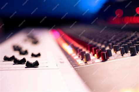 free photo control room desk with motorized faders and multiple knobs