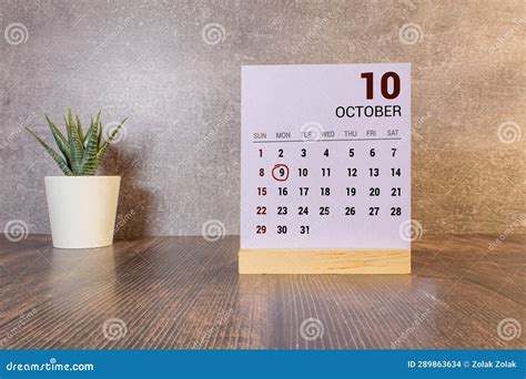 Cube Shape Calendar For October 09 On Wooden Surface With Empty Space