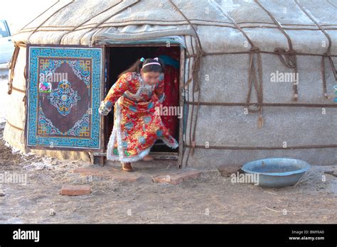 Mongolian Girl Walking Out From The Yurt Ujimqin Grassland East