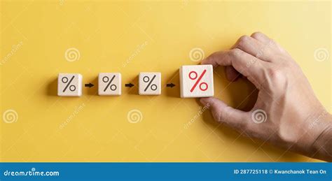 Hand Holding Wood Block With Percentage Sign Interest Rate And Dividend Interest Rates Continue