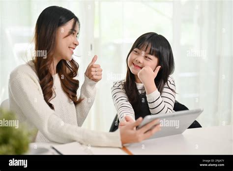 Cheerful And Happy Asian Mom And Her Daughter Spending Time Together At