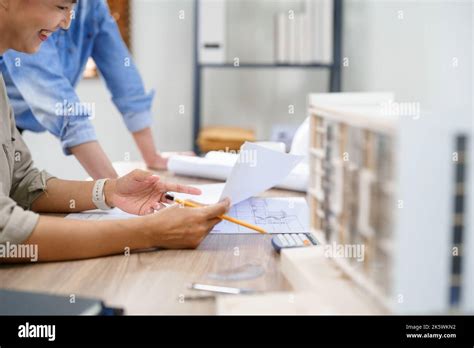Concept Of Engineering Consulting Two Female Engineers Is Checking Blueprint Of Building