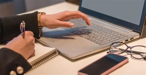 Close Up Of A Hands Scrolling On A Laptop And Something Written On