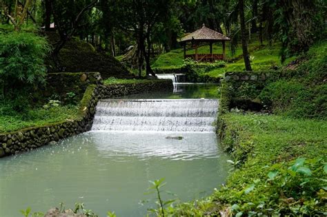Premium Photo A Waterfall In A Garden Decorated With A Gazebo In The