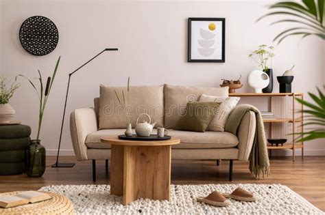 Domestic And Cozy Interior Of Living Room With Beige Sofa Plants