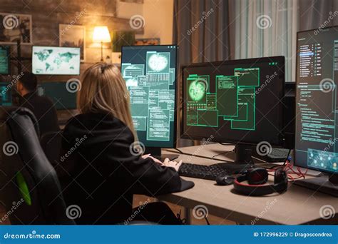 Female Hacker Using Keyboard To Type A Dangerous Malware Stock Image