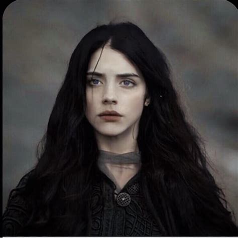 A Woman With Long Black Hair And Blue Eyes