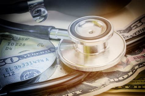 Stethoscope And Money In Soft Light For Medical Cost Saving Stock Image