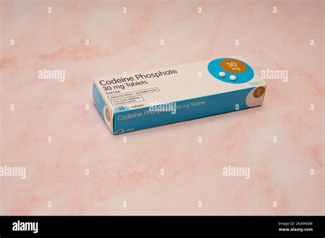 Two 30mg Codeine Phosphate On Top Of Box Of 28 Isolated On Marble Pink
