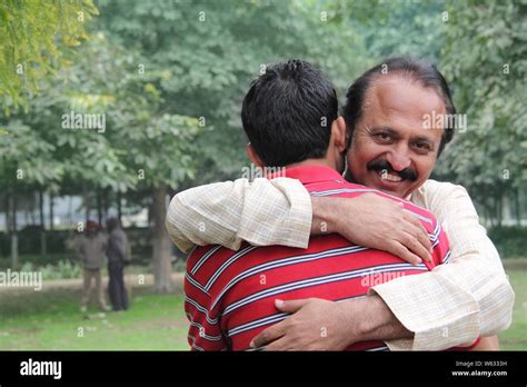 Man Hugging His Son And Smiling Stock Photo Alamy