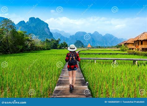 Tourism With Backpack Walking On Wooden Path Vang Vieng In Laos Stock
