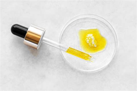 Liquid Yellow Medicine Mixture On Measuring Spoon On A Blue Background