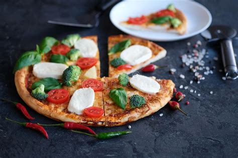 Sliced Pizza With Mozzarella Cheese Tomatoes Broccoli Spices And