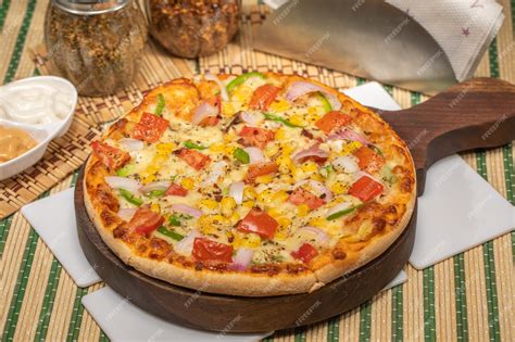 Premium Photo Veg Pizza On Wooden Pizza Board Isolated Over A Rustic