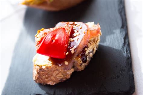 Premium Photo Ham And Pepper Tapa A Small Slice Of Bread On Which A Small Portion Of Food Is