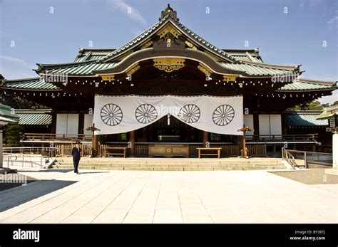 The Main Hall Haiden Of Yasukuni Shinto Shrine Tokyo Japan In Front Stands A Security Guard